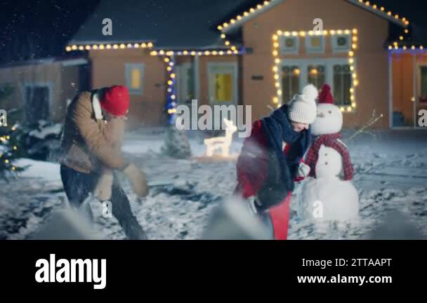 Young Beautiful Couple Throw Snowballs with Their Lovely House in the ...