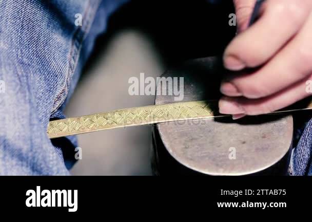 Traditional tinsmith work. Copper smith makes embossing artifacts from ...