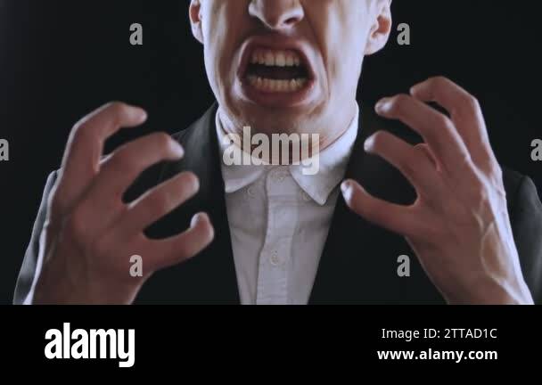 aggressive businessman in a suit is screaming and showing anger on a ...