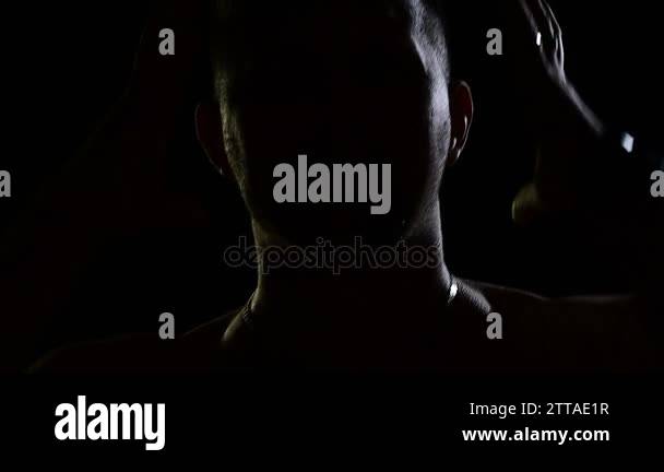 Man in the dark emotionally sings. Silhouettes of men, portrait in dark ...