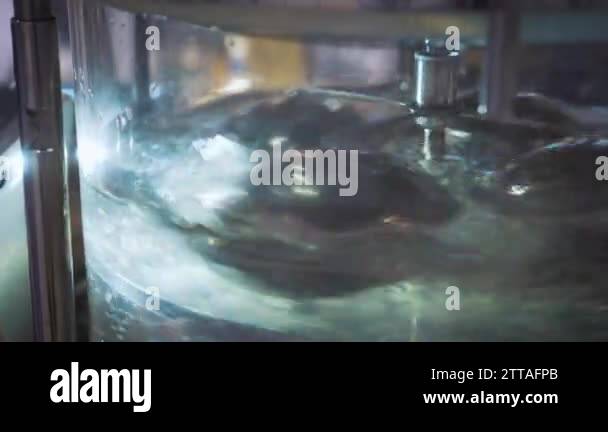 Transparent liquid, can water. Abstractly rotates and is stirred in an ...