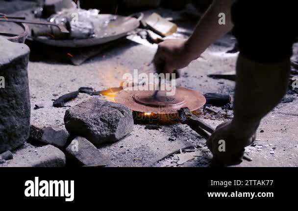 Traditional tinsmith work. Copper smith makes embossing artifacts from ...
