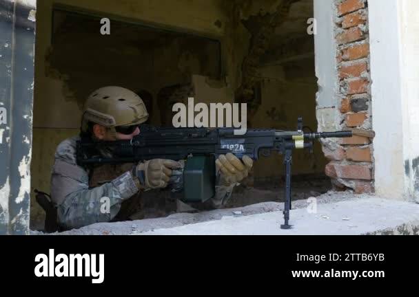 Marine soldier mounting shotgun on window defending ruined building ...