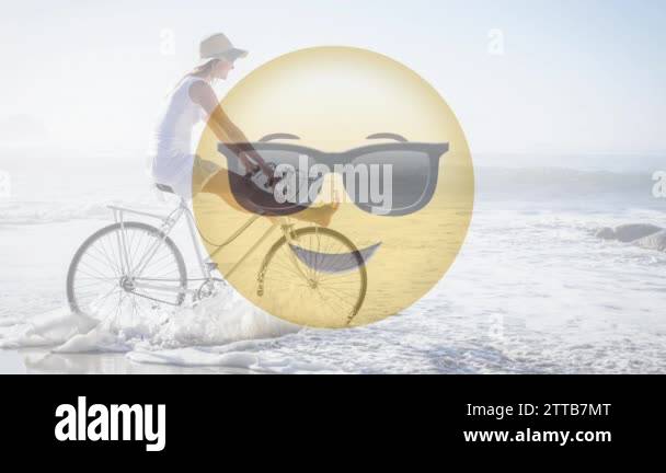Animated Yellow Emoticon with sunglasses against woman driving bike ...