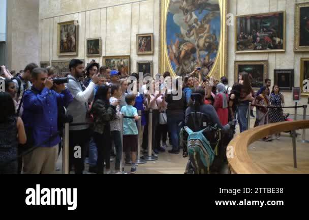 People waiting on queue to see the Mona Lisa painting at the Louvre ...