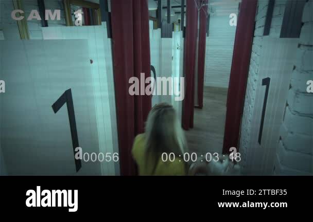 CCTV security cam footage of people in a fitting room in a department ...