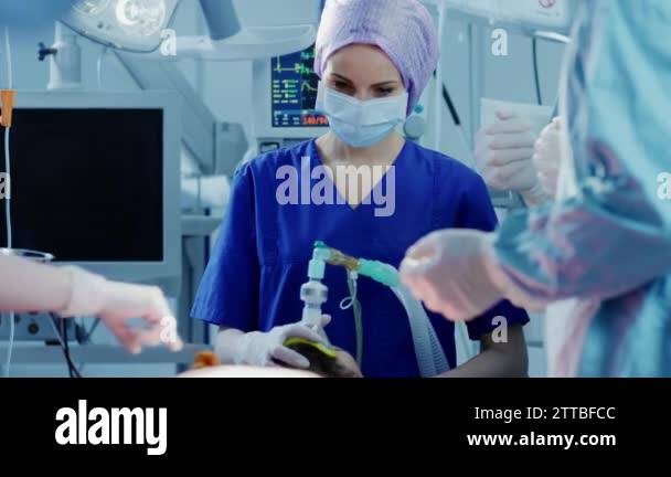 In the Hospital Operating Room Anesthesiologist Applies Anesthesia Mask ...