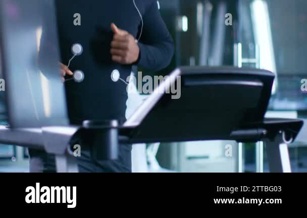Male Athlete Runs on a Treadmill with Electrodes Attached to His Body ...