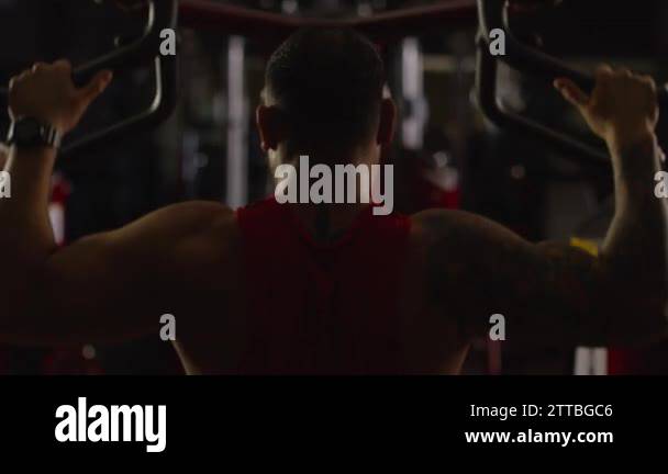 Sportsman athlete bodybuilder trains in the gym. Handsome muscular ...