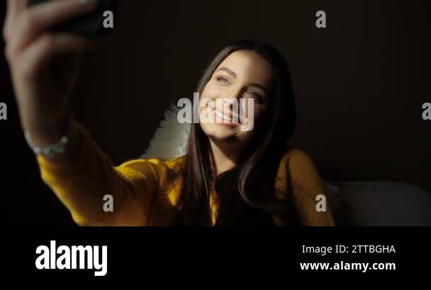 Beautiful brunette woman taking selfie indoor. Pretty young woman ...