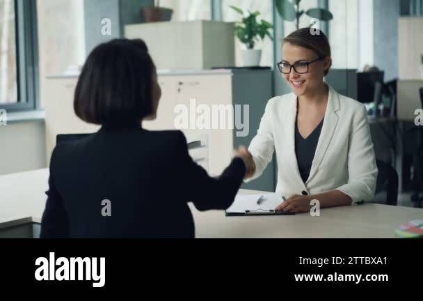 Good-looking young lady from human resources department is interviewing ...