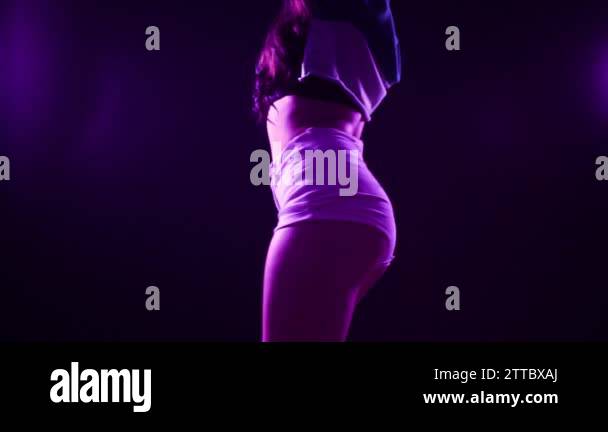 Attractive brunette woman wearing white short shorts and top dancing ...