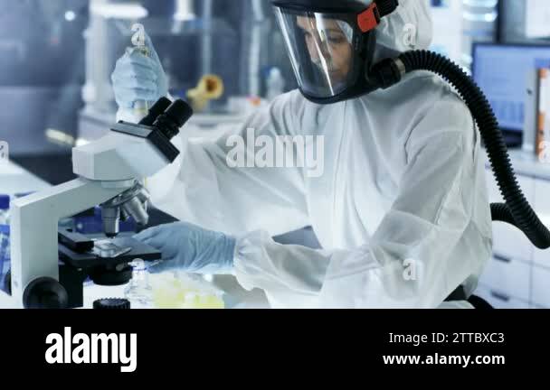Medical Virology Research Scientist Works in a Hazmat Suit with Mask ...