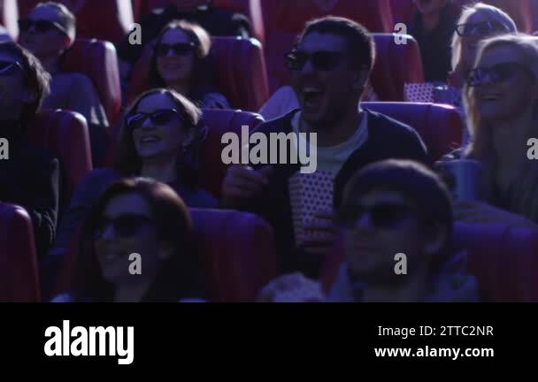 Group of people in 3d glasses are laughing while watching a comedy film ...
