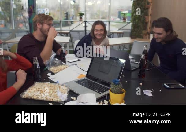 Five diverse colleagues in cheer mood clinking glasses with pepsi while ...