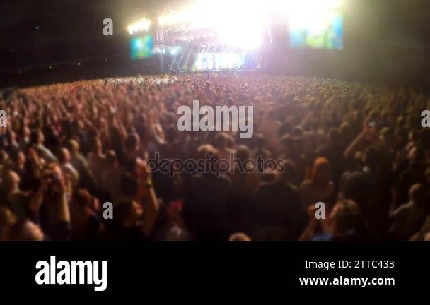 Crowd of people putting hands in air and clapping, fans at concert ...