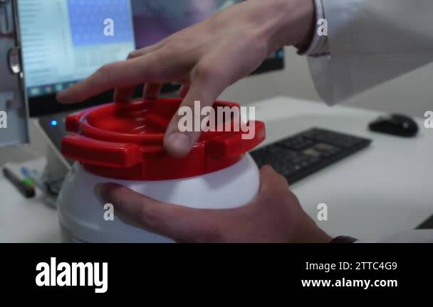Chemical scientist opening white unlabeled plastic tank canister with ...