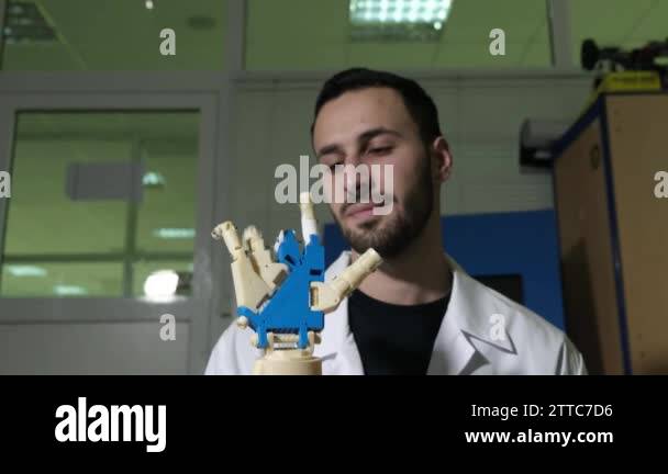 male engineer scientist experiences a bionic prosthesis of a mechanical ...