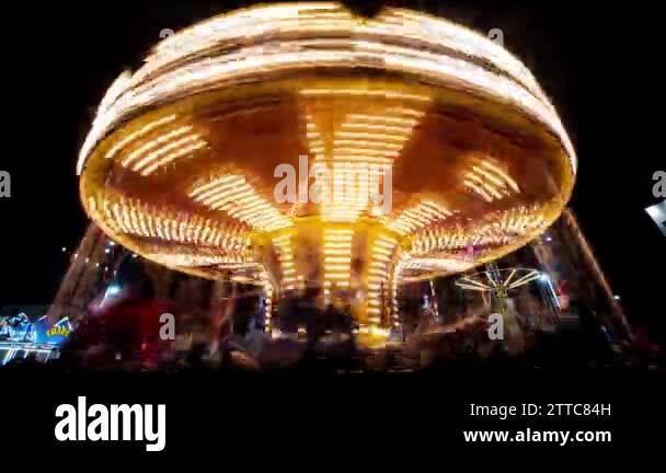 Merry-go-round carousel at night. Amusement park carousel with ...