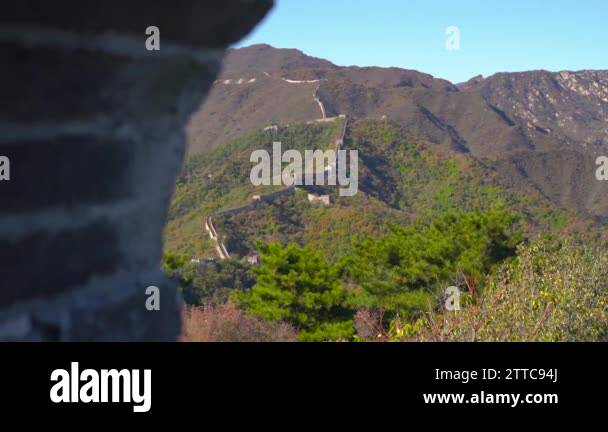 Steadicam shot of the Chinese Great wall that rises up the side of the ...
