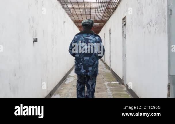 Prison officer walking in inter yard in russian penitentiary colony ...