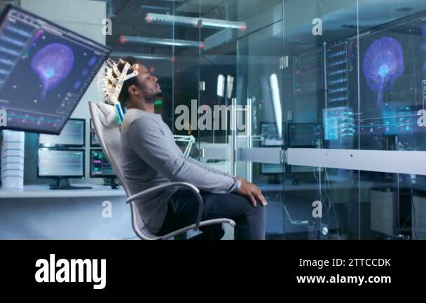 In Laboratory Man Wearing Brainwave Scanning Headset Sits in a Chair ...