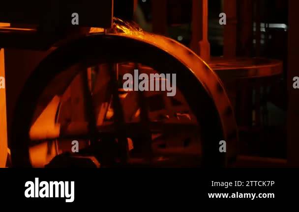 Water stream moving a wooden wheel of an ancient mill model in dark ...