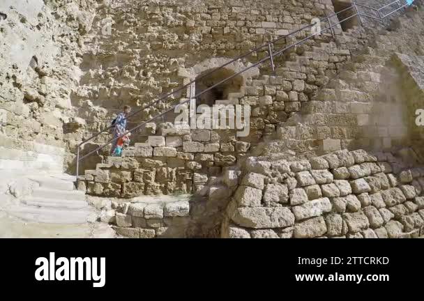 Father and his toddler son travelers climbs up stairs on medieval ...