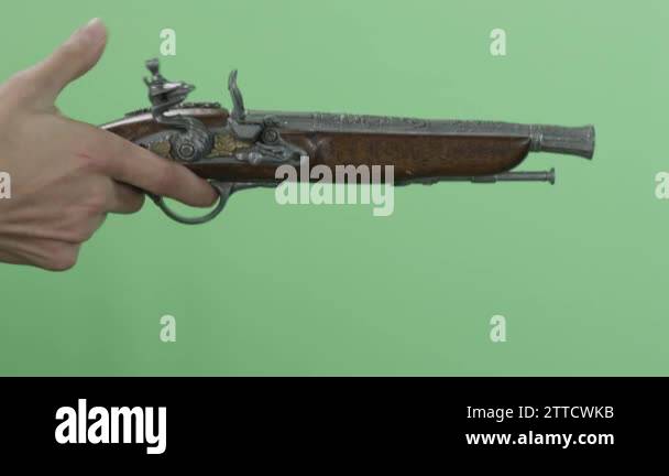 Man with an old pistol. Vintage antique flintlock pistol isolated on ...