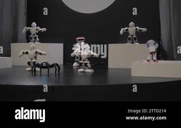 humanoid robot dance. Group of cute robots dancing. Close up of smart robot dance show. Humanoid ...