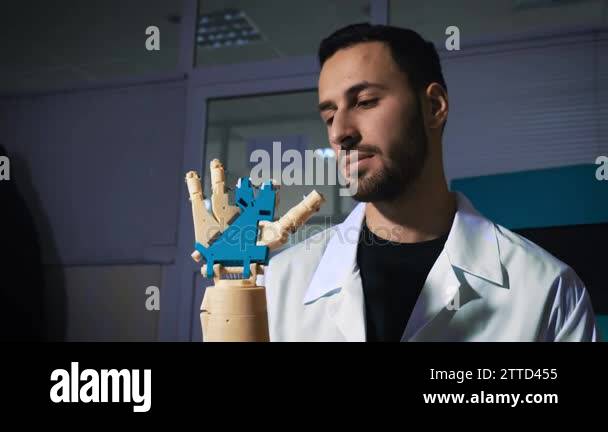male engineer scientist experiences a bionic prosthesis of a mechanical ...