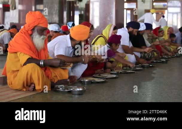 Poor indian people eating free food at a soup kitchen in the Sikh ...