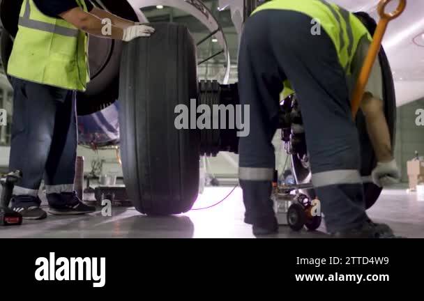 Airport worker checking chassis. Engine and chassis of the passenger ...