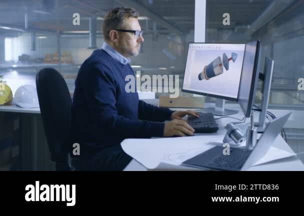 Chief Male Engineer Working on Big Technical Project Creating 3D Turbine/ Engine Model on His ...