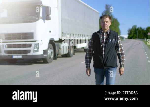 Professional Driver Gets out of the Parked White Semi Truck with Cargo ...