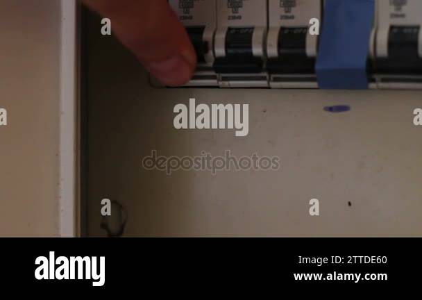 Female hand toggle switch in the switch box, All switches being turned ...