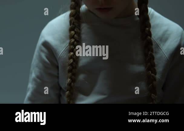 Girl showing drawing with burning house into camera, victim of disaster ...