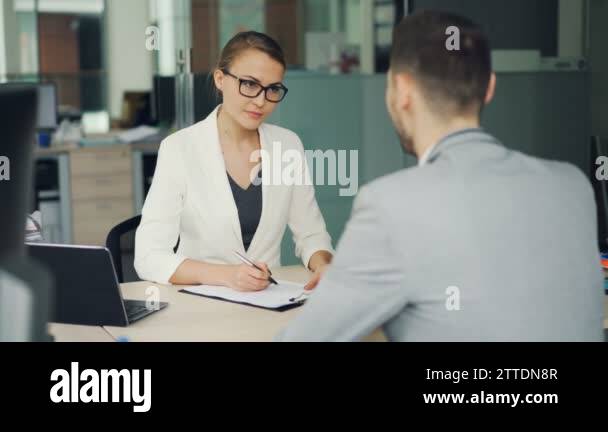 Pretty woman recruiter is talking to male candidate during job ...
