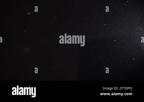 Dust particles in a light beam in a black room background Stock Video ...