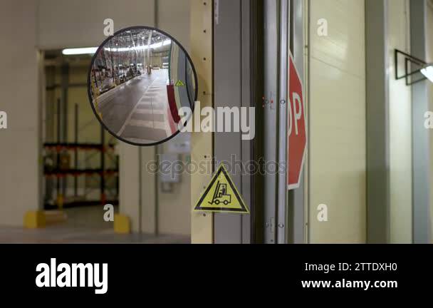 young man in working clothes, driver Reachtruck busy working on the ...