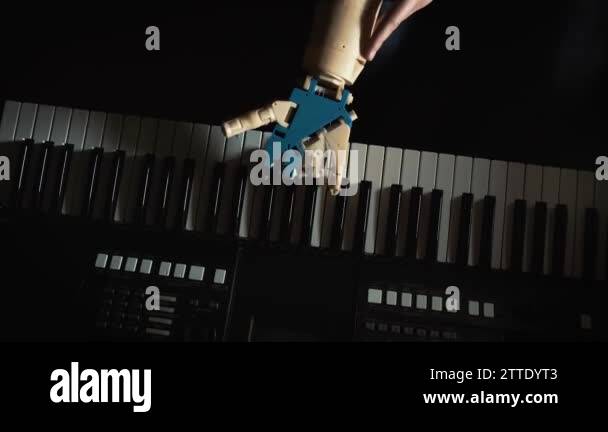 Robot plays a musical instrument. man musician pianist with a ...