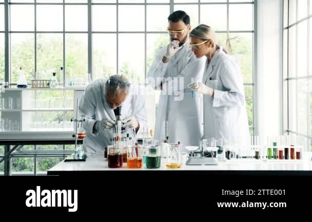 Group of chemists working in a lab. Young white male and female ...