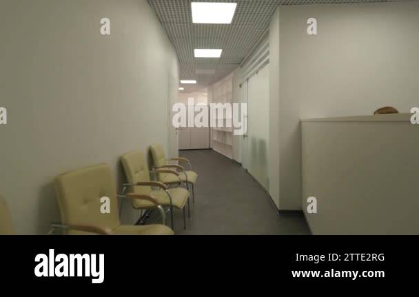 Long, arcuate office hallway and a reception desk. Corridor of a public ...