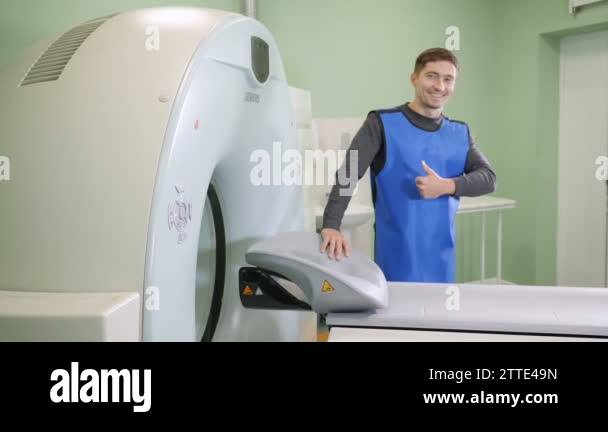 Computer tomography concept. Young male patient near CT MRI scanner ...