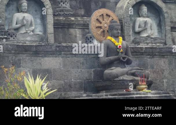 Buda statue in the temple island of Bali Stock Video Footage - Alamy