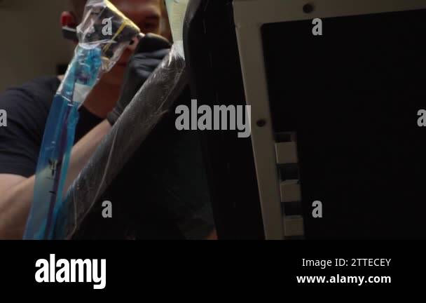 Man with a Bluetooth headset makes a tattoo in a tattoo parlor Stock ...