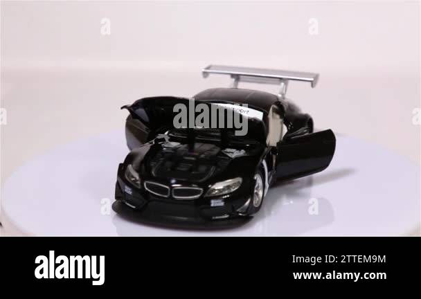 BERLIN, GERMANY - JANUARY. 2019: Black BMW 24 GT3 scale model sports car with opened doors and ...