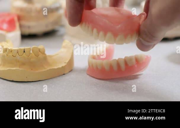 Examination of dentures in the dental laboratory Stock Video Footage - Alamy