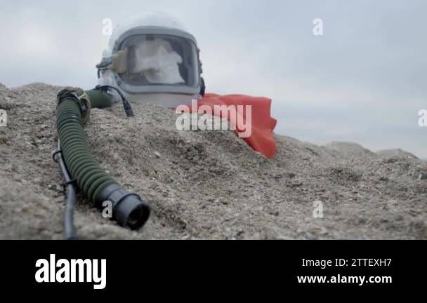 The head of a dead cosmonaut lies on the sand by the sea. Astronaut ...