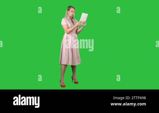 Single girl making a video call on her tablet side view full lenth on a ...